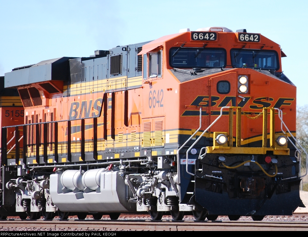 Up/close shot of a still Very Clean BNSF 6642 as she pulls a Bear Taale load (empty spine cars ...